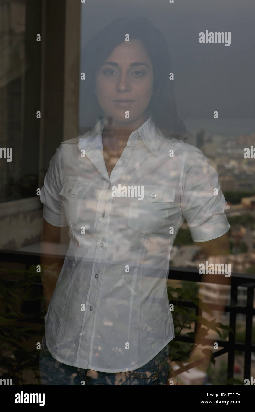 Reflection of a woman in a window glass, Haryana, India Stock Photo - Alamy