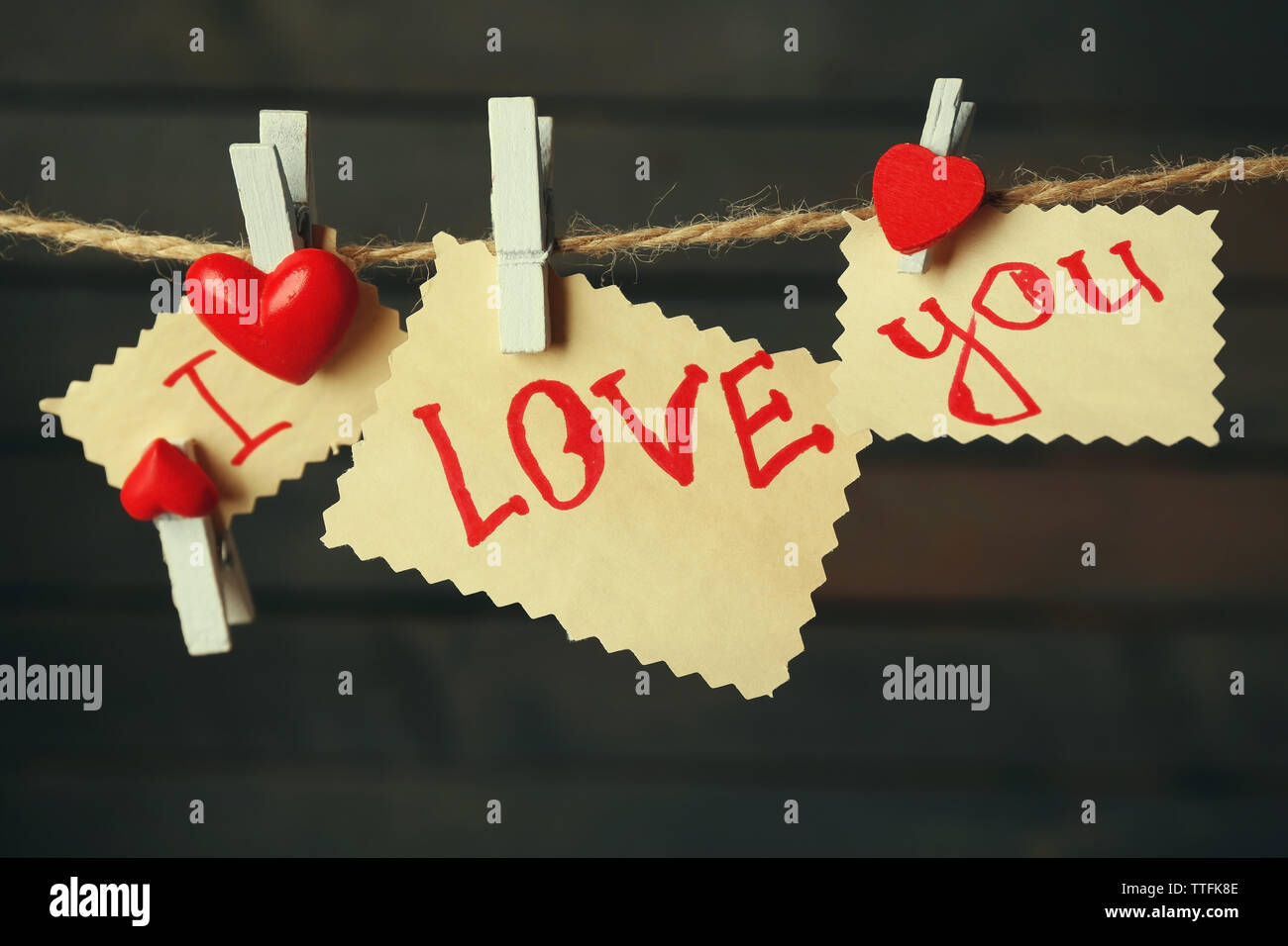 Valentine's Day card with hearts and words of love on wooden background ...