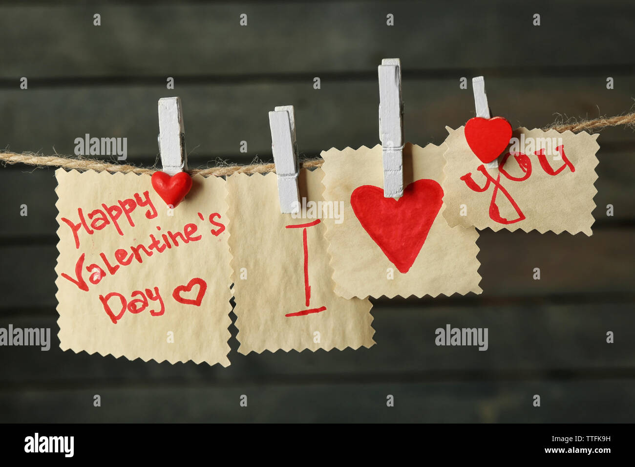 Valentine's Day card with hearts and words of love on wooden background ...