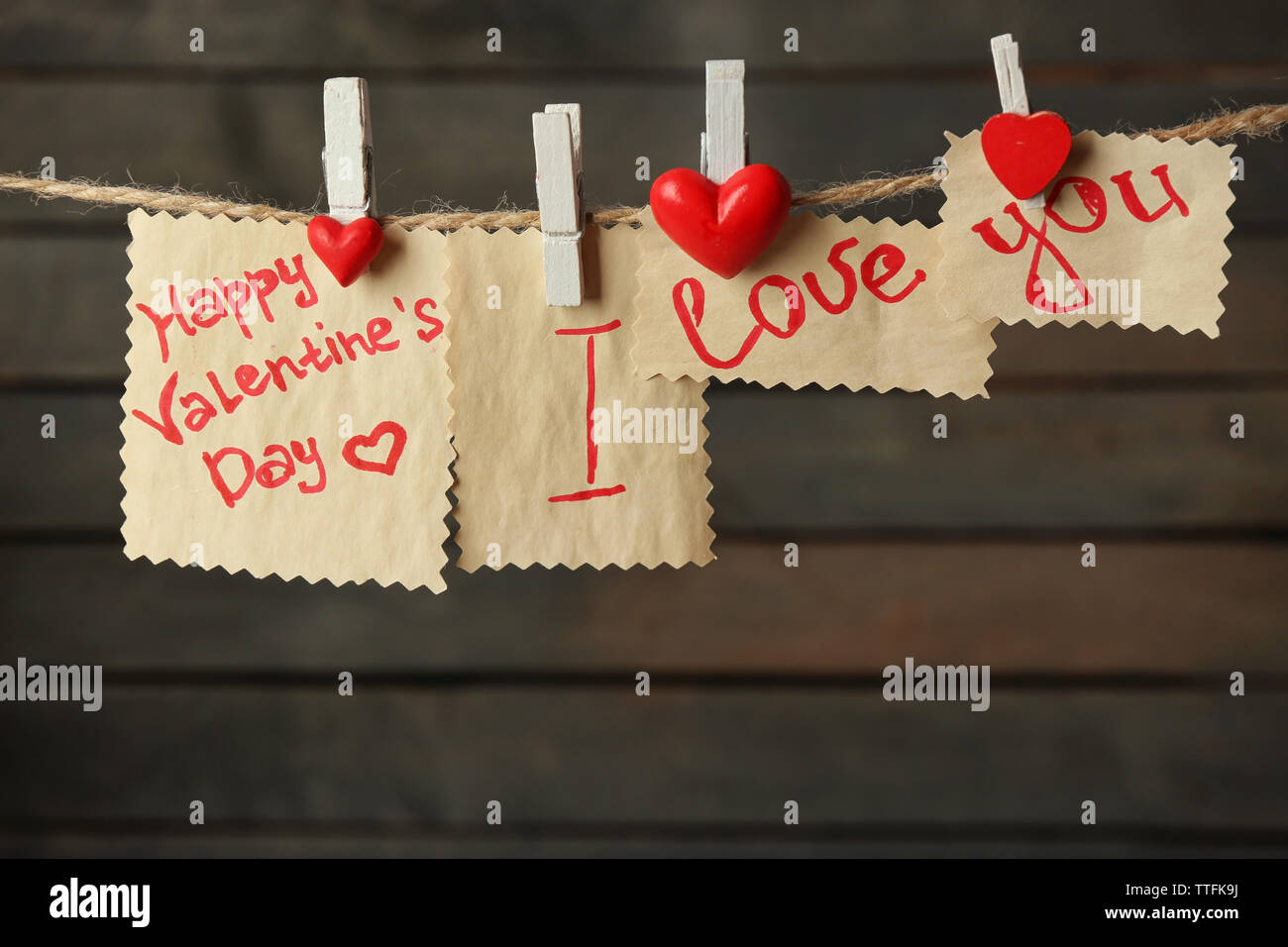 Valentine's Day card with hearts and words of love on wooden background ...