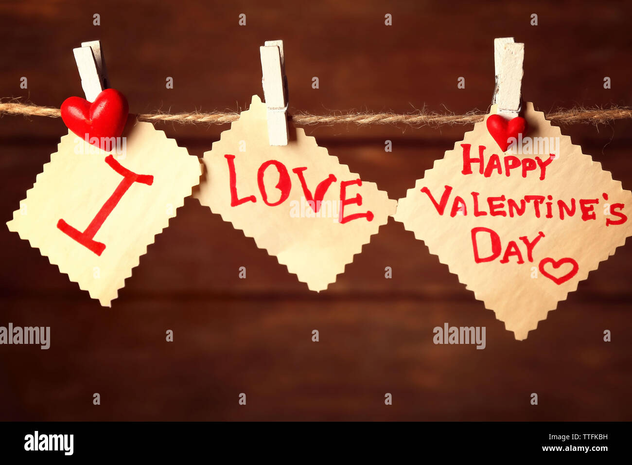 Valentine's Day card with hearts and words of love on wooden background ...