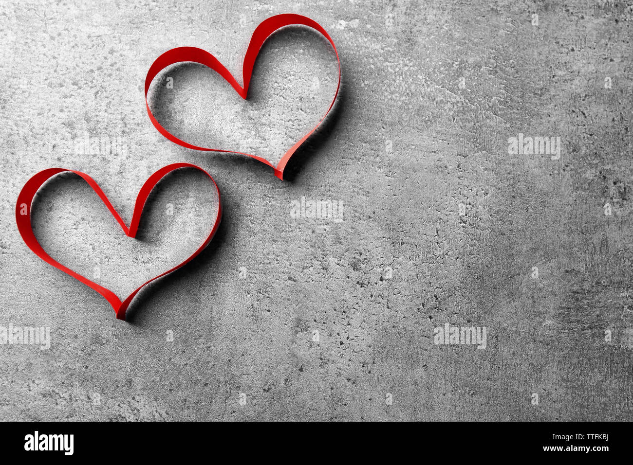 Valentine's Day heart made of ribbon on dark background Stock Photo - Alamy