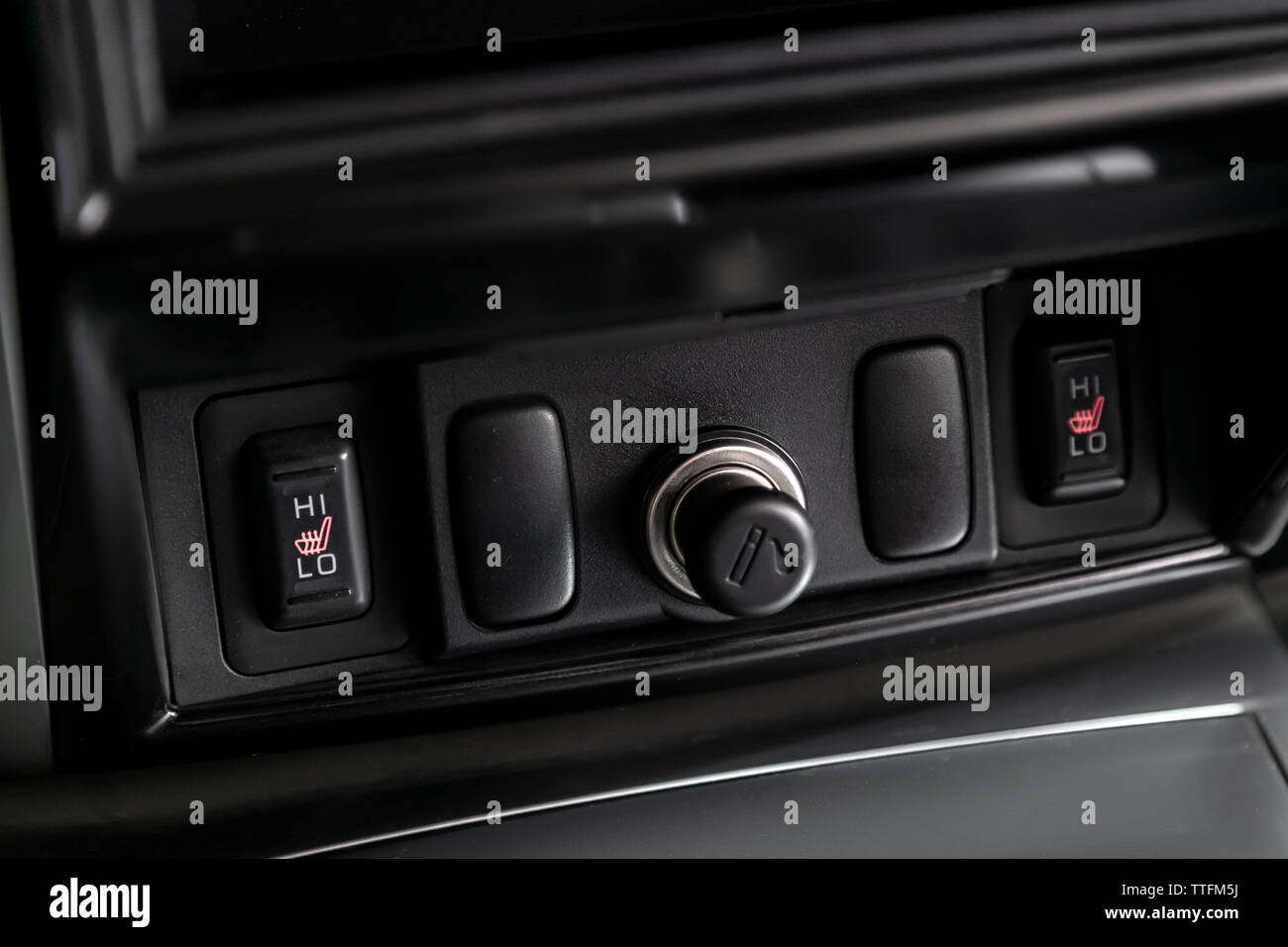 Close-up of seat heating buttons and charging in the car, cigarette ...