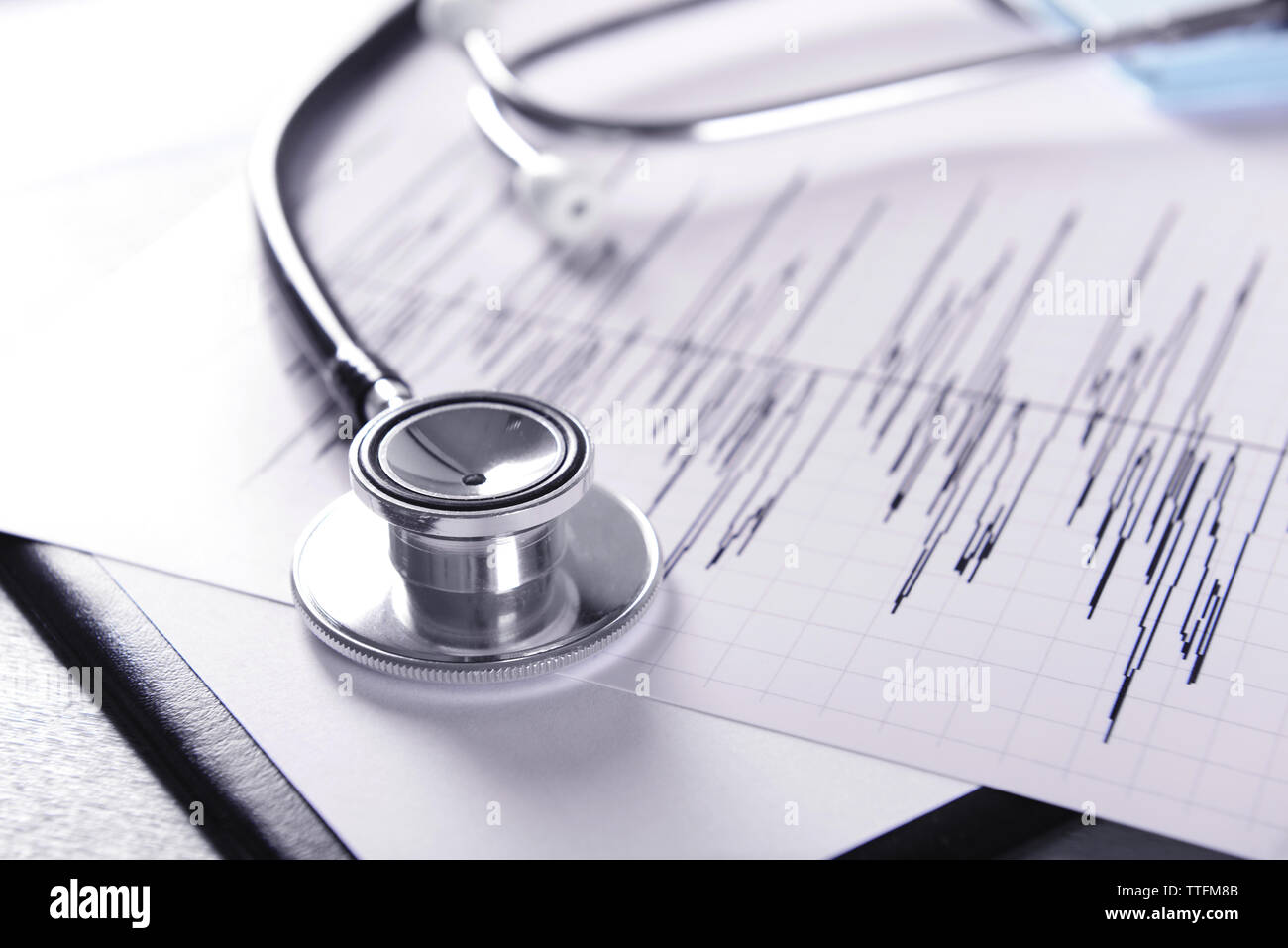 Cardiogram chart with medical stethoscope on table closeup Stock Photo ...