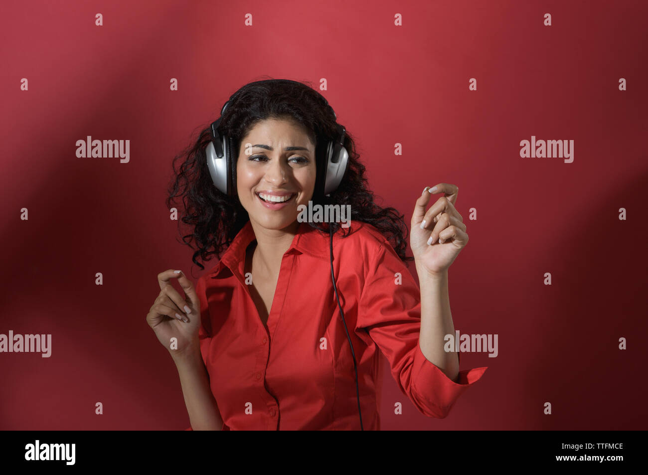 Young woman listening to music with headphones and dancing Stock Photo ...