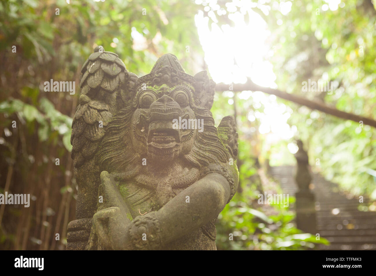 Stone carved demon Balinese statue with trees in the background, UBUD ...