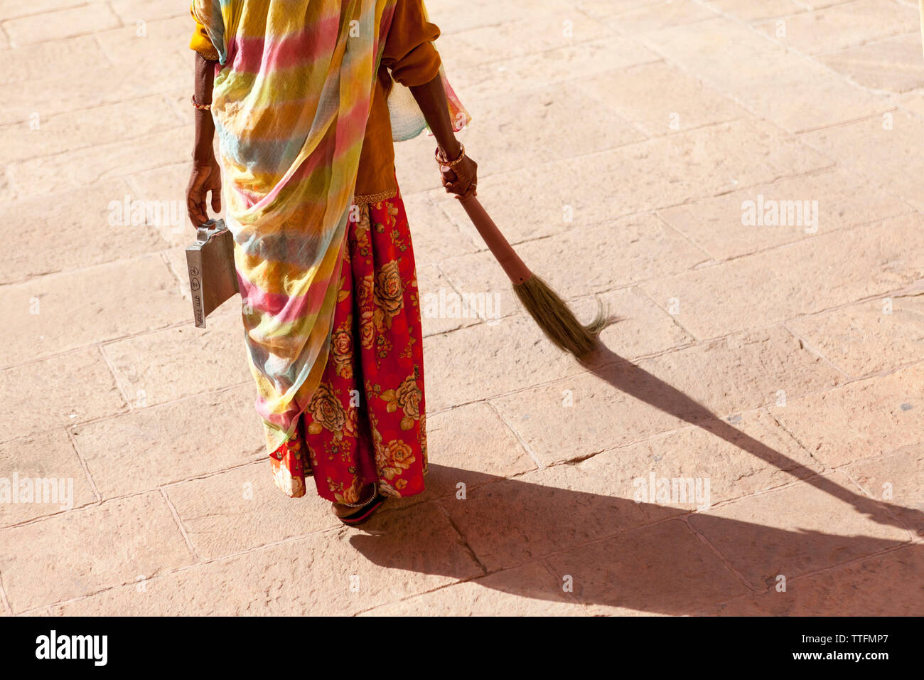Indian woman sweeper with colorful Sarees sweeping the street Stock ...