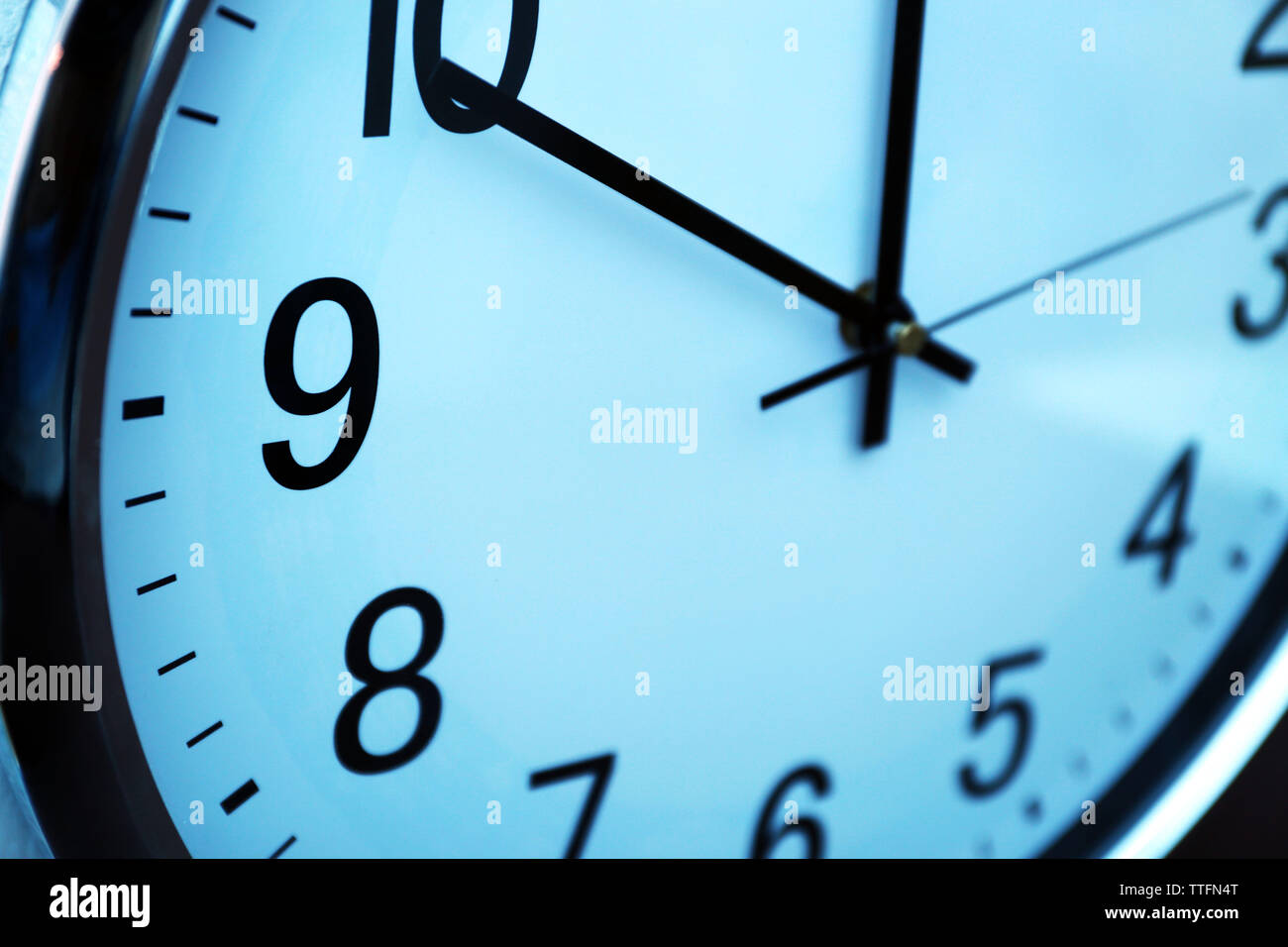 Clock face in blue light closeup Stock Photo - Alamy