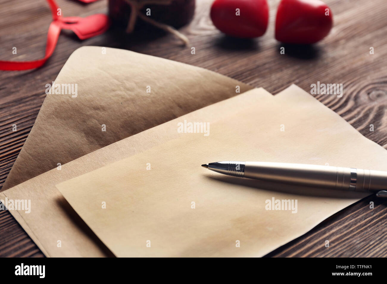 Gift card for Valentine's Day with pen and envelope on wooden ...