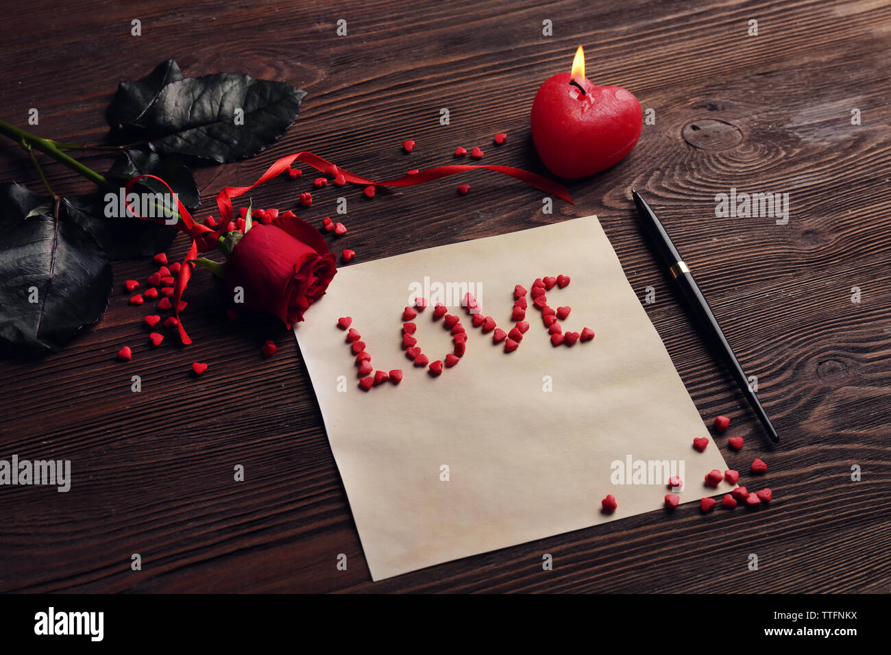 Gift card for Valentine's Day with love word, red rose, pen and candle ...