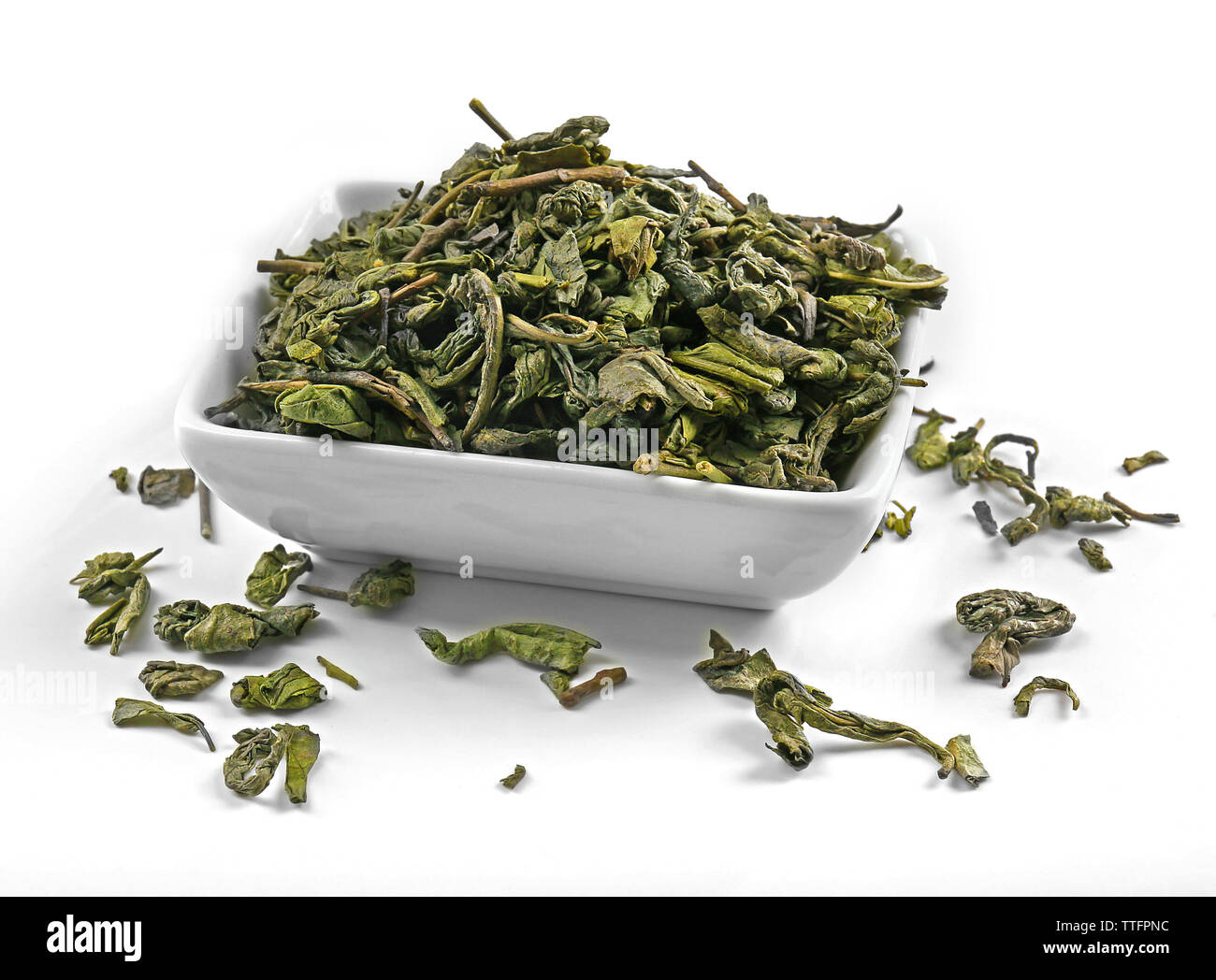 Dry tea leaves in bowl, isolated on white Stock Photo - Alamy