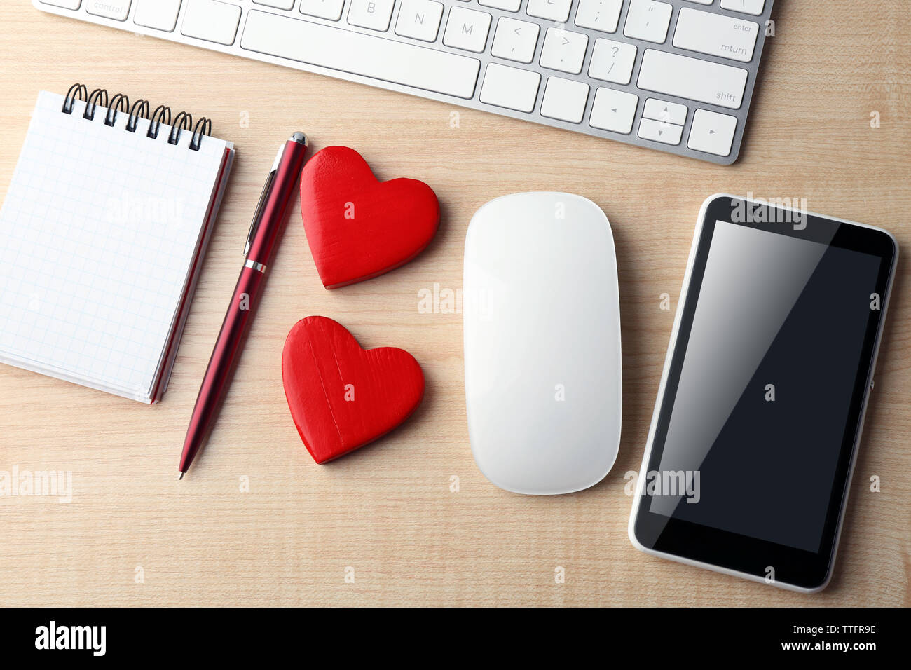 Computer peripherals with red hearts, notebook and mobile phone on ...