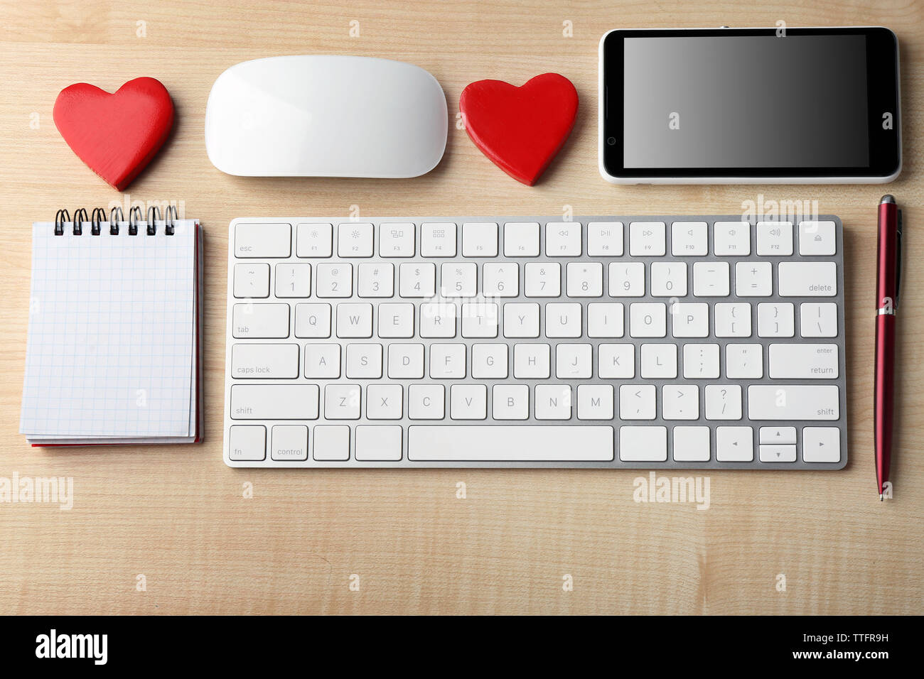Computer peripherals with red hearts, notebook and mobile phone on ...