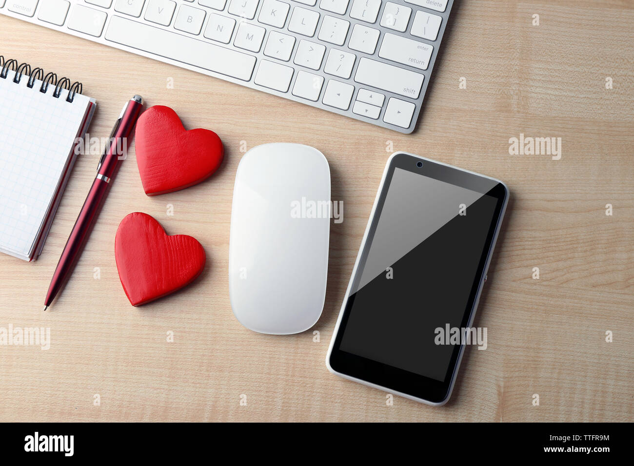 Computer peripherals with red hearts, notebook and mobile phone on ...