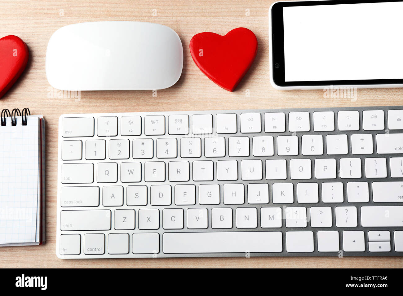 Computer peripherals with red hearts, notebook and mobile phone on ...