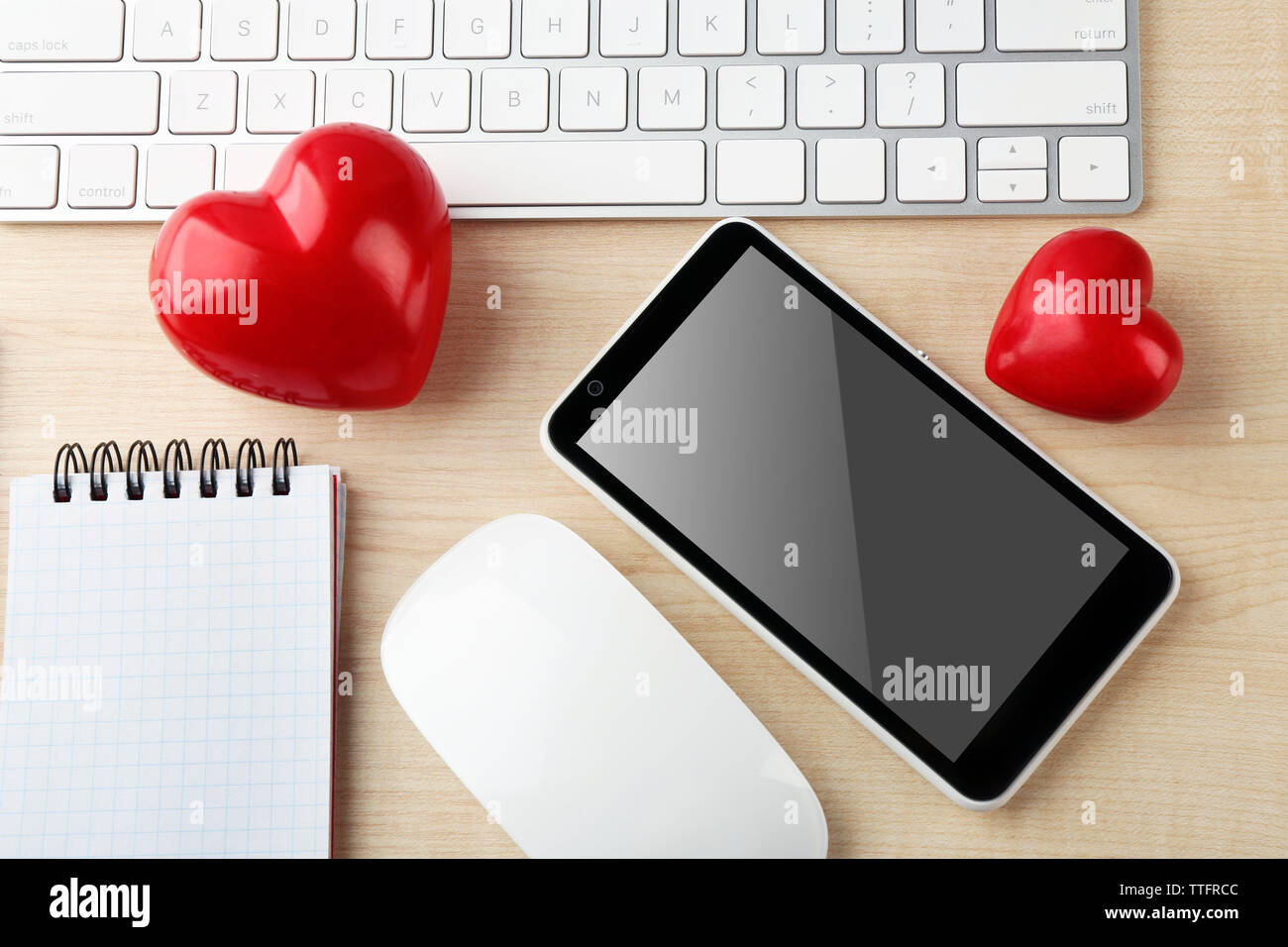 Computer peripherals with red hearts, notebook and mobile phone on ...