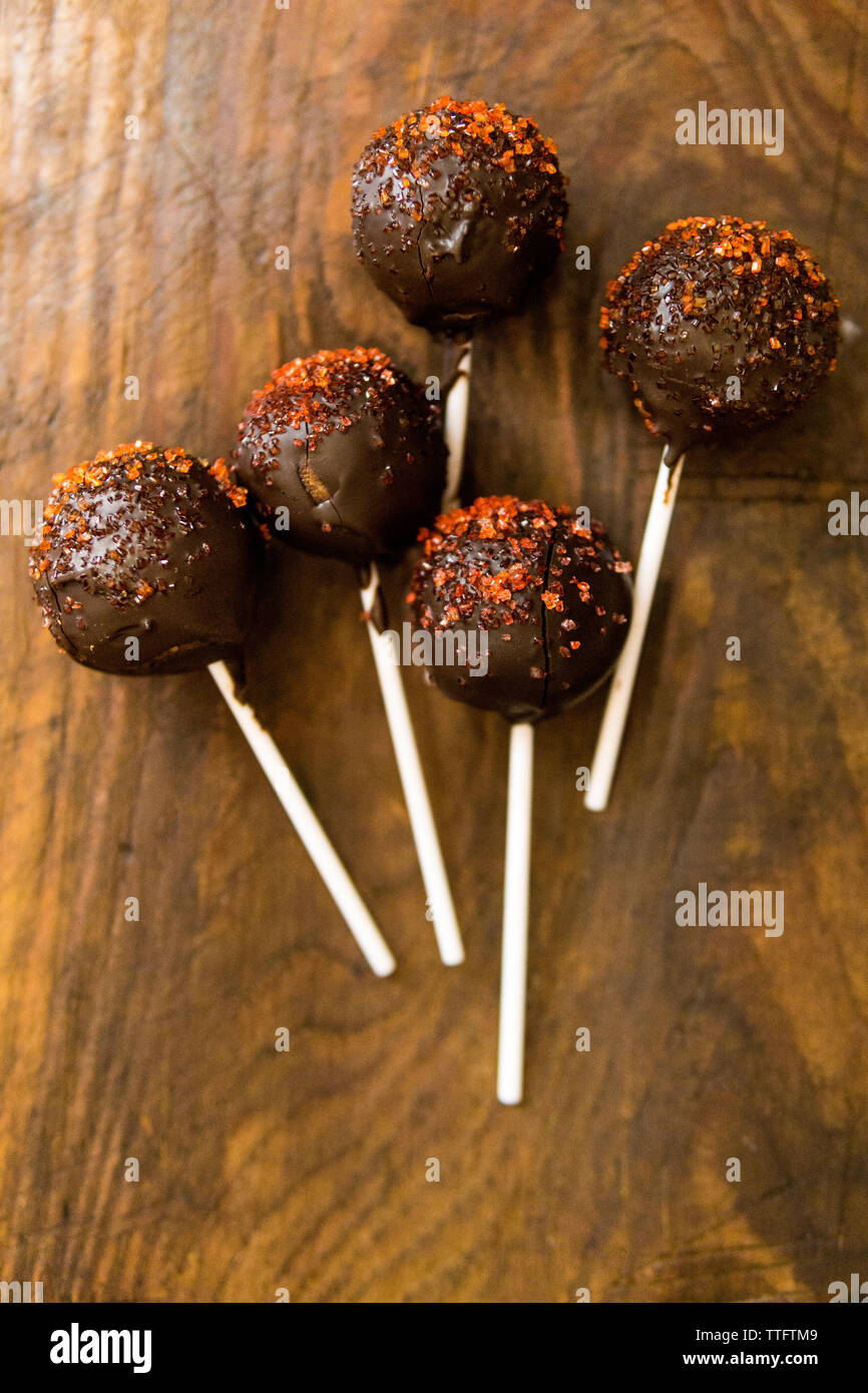 tasty chocolate cake pops ready to eat on a old wood table Stock Photo ...