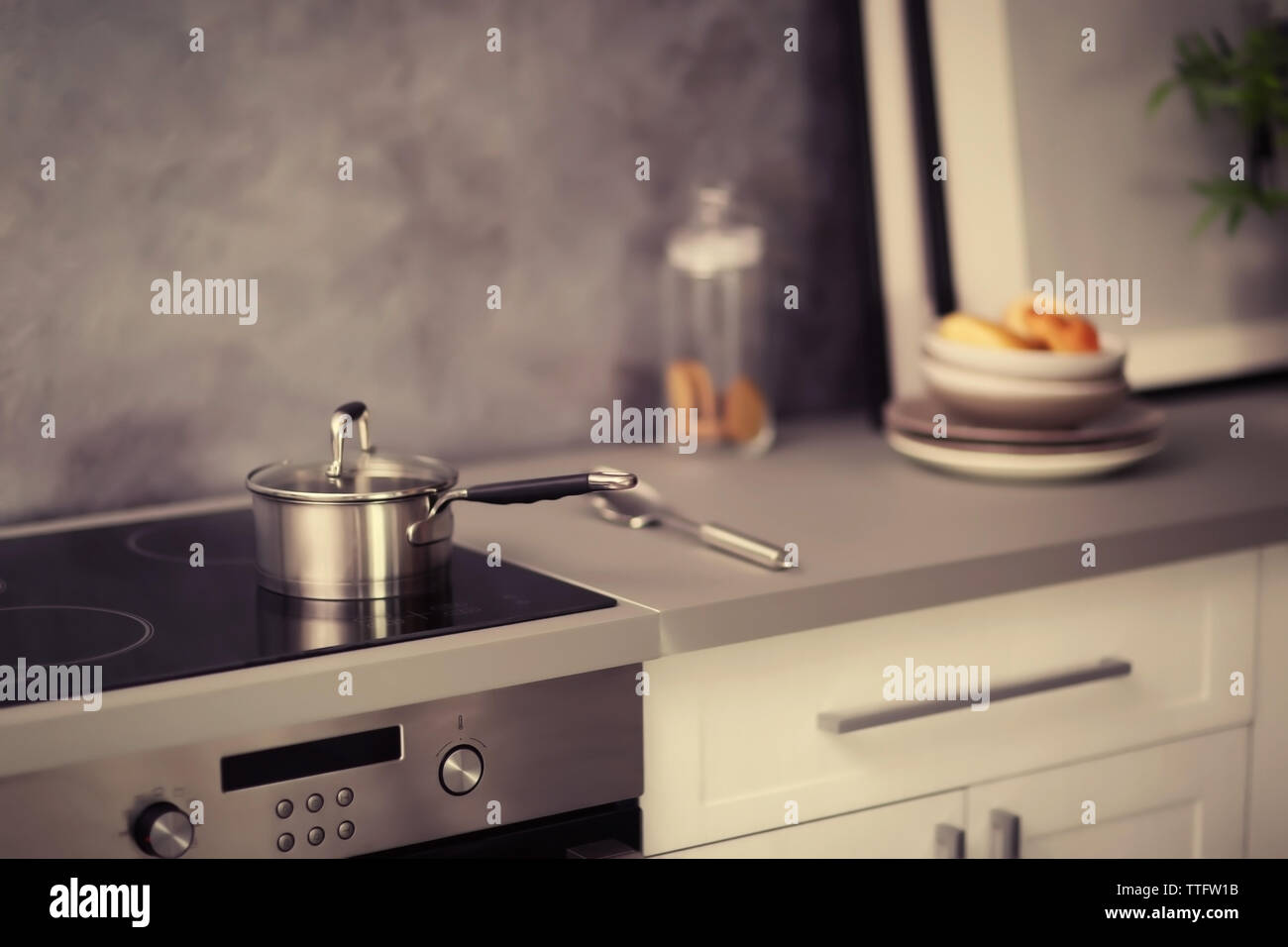 Modern electric stove with utensils in the kitchen Stock Photo - Alamy