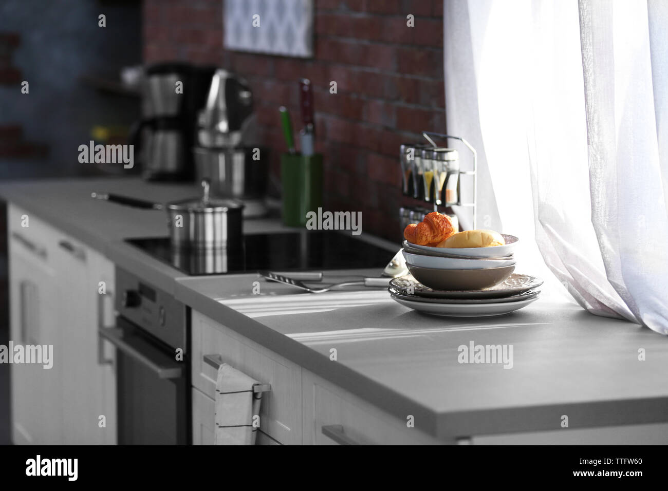 Modern kitchen table with electric stove beside the window Stock Photo ...