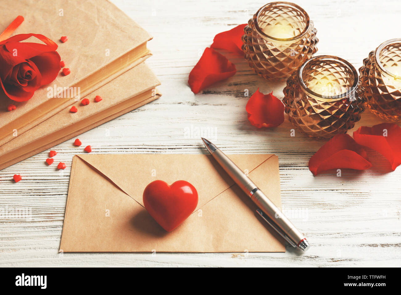 Gift card for Valentine's Day with pen and candles on white wooden ...