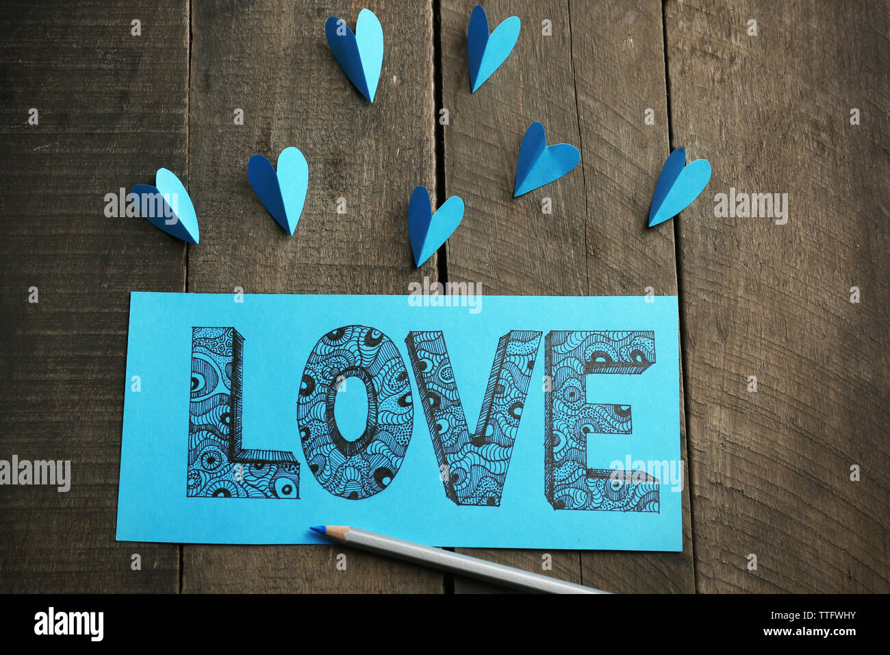 Blue gift card with love doodle drawing on wooden background Stock ...