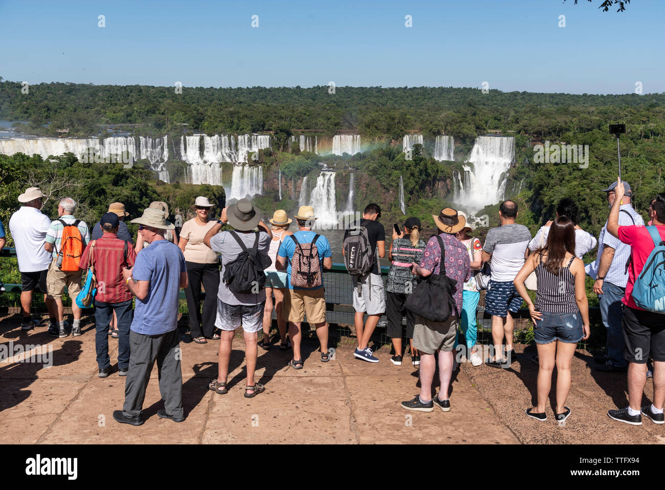 Beautiful landscape of tourists visiting big waterfalls Stock Photo - Alamy