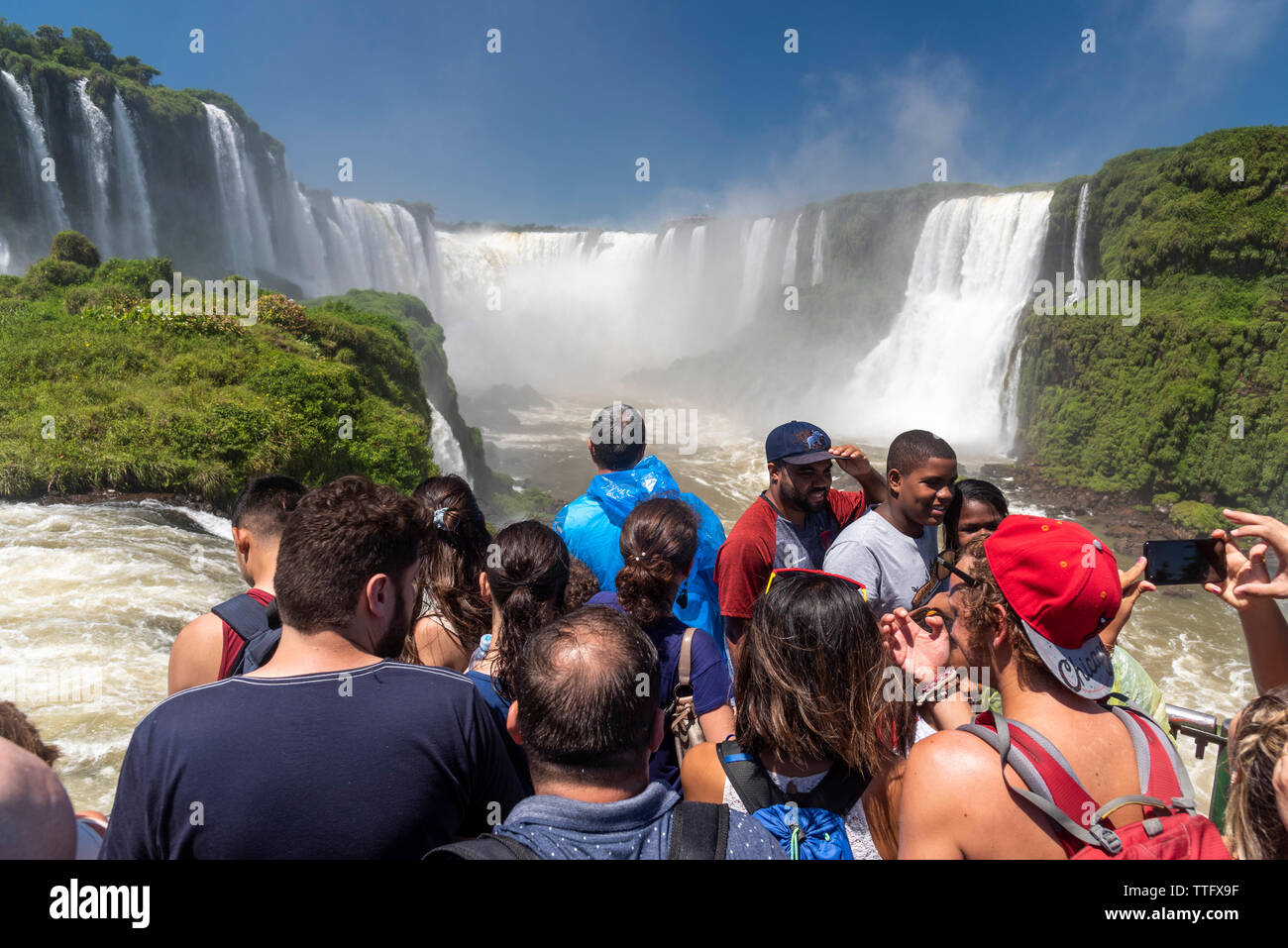 Beautiful landscape of tourists visiting big waterfalls on rainforest ...