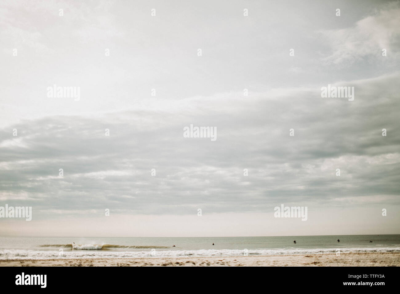 a wave crashing in the ocean, shot from the beach, faded colors Stock ...
