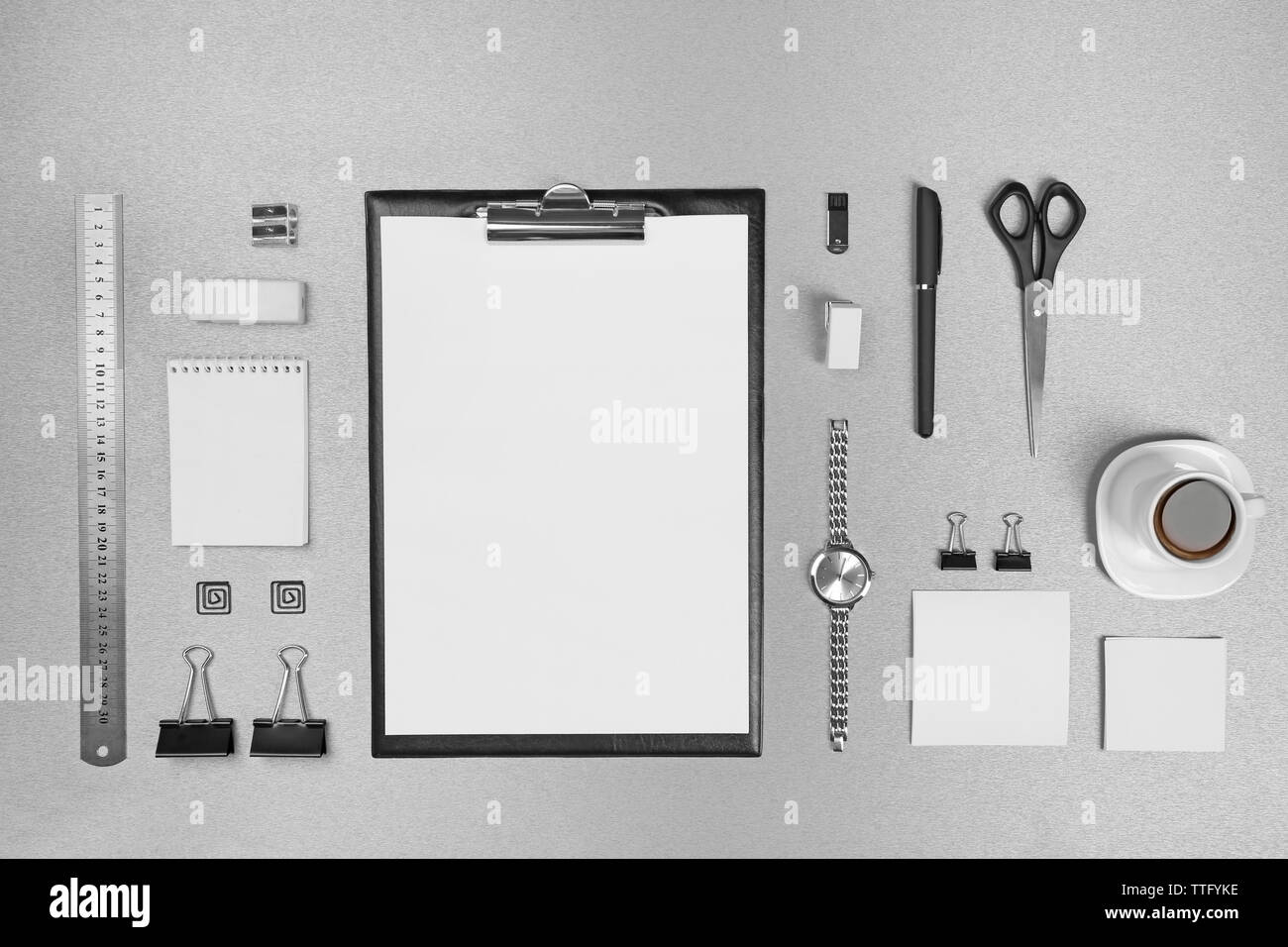 Office set with white sheets of paper, cup of coffee, watch and ...