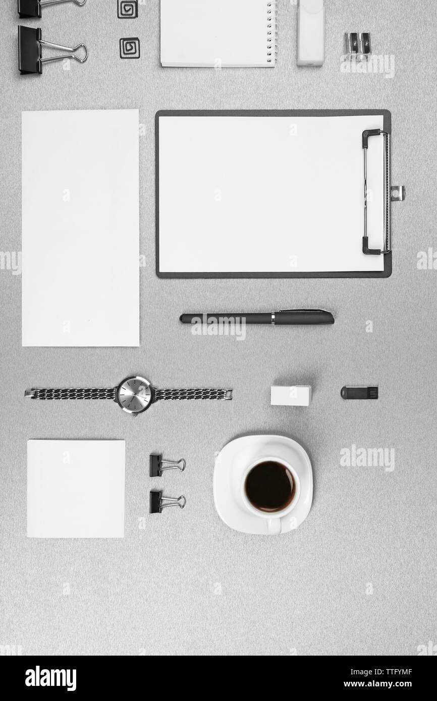 Office set with white sheets of paper, cup of coffee, watch and ...