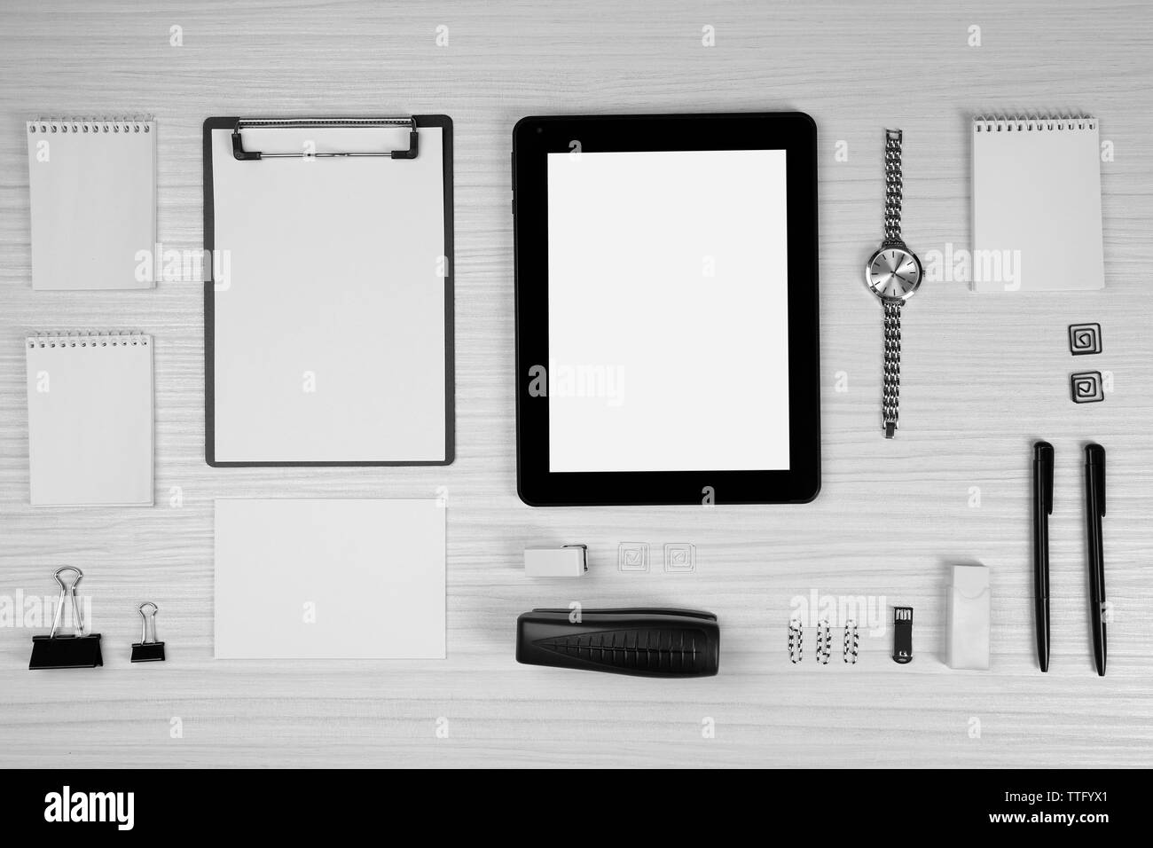 Office set with sheets of paper, tablet and stationery on light wooden ...