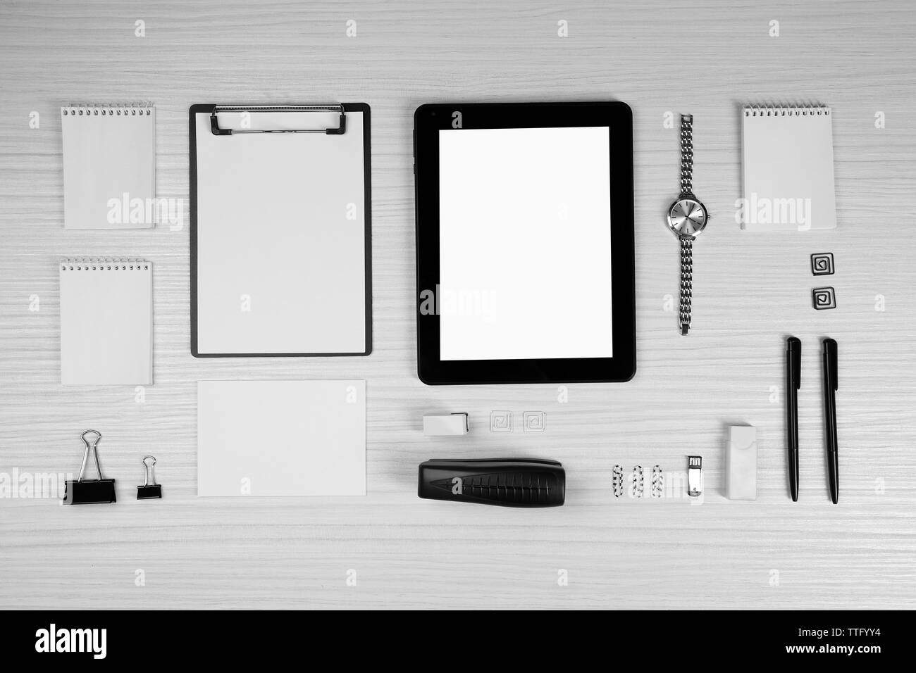 Office set with sheets of paper, tablet and stationery on light wooden ...