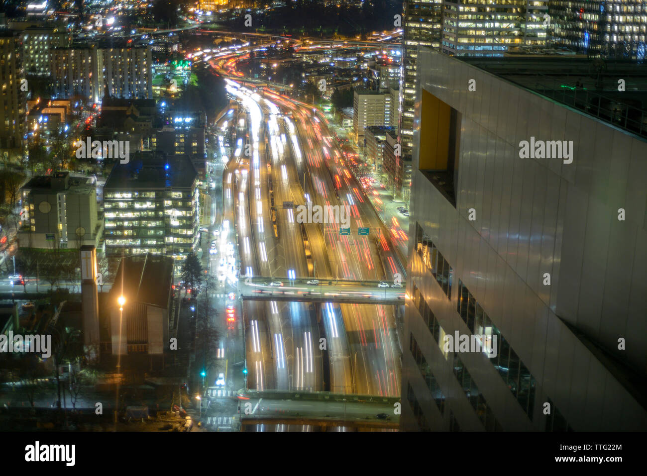 Cars Driving at Night on Interstate Highway Through A City From Above ...