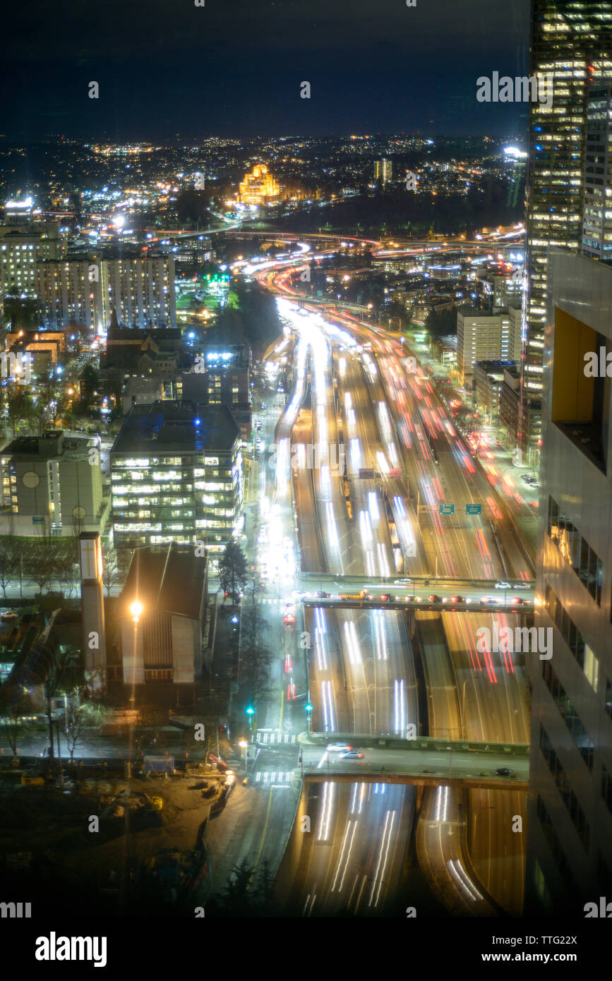 Cars Driving at Night on Interstate Highway Through A City From Above ...