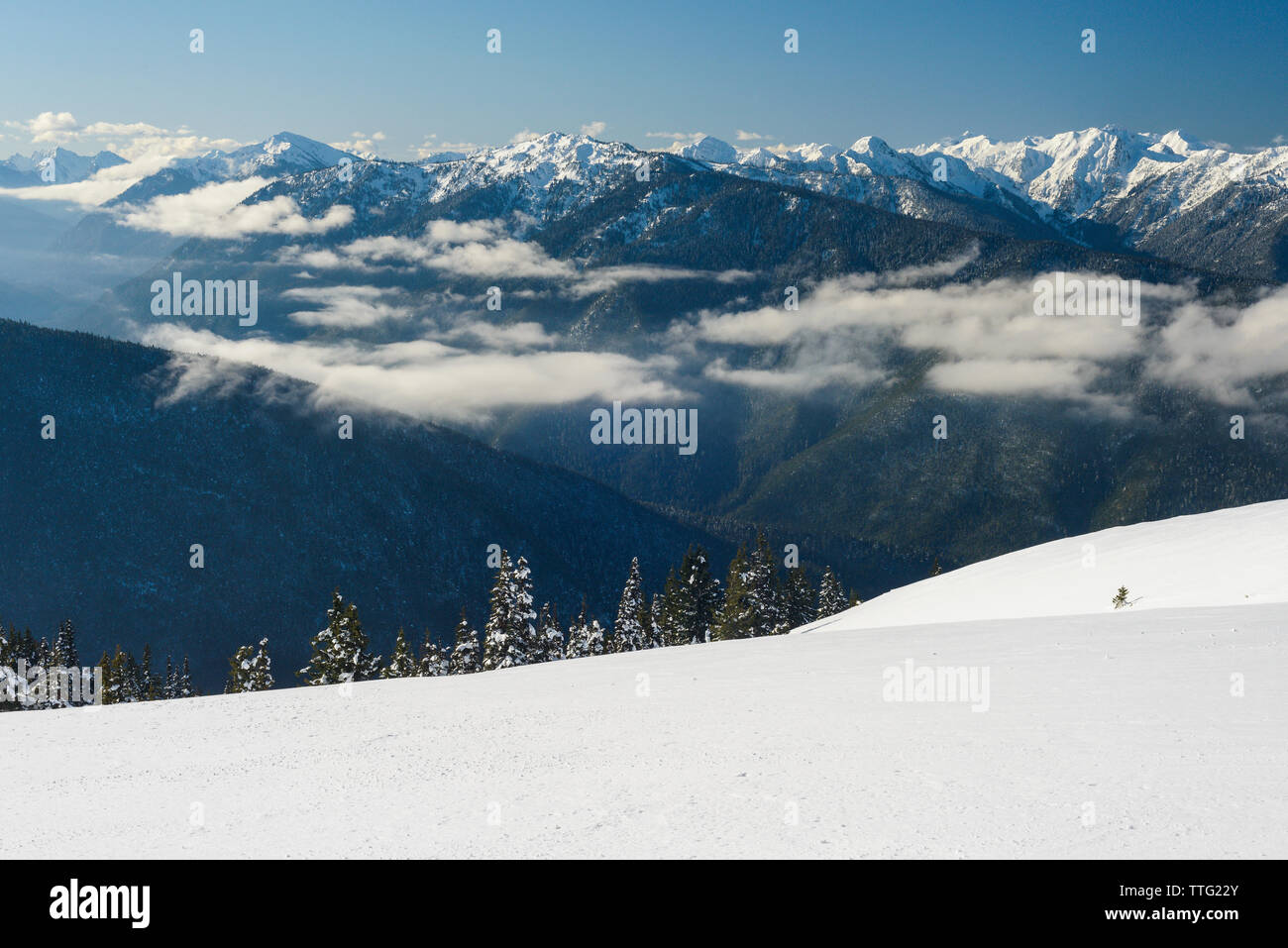 Snowy Mountain Range in Winter With Clouds Stock Photo - Alamy