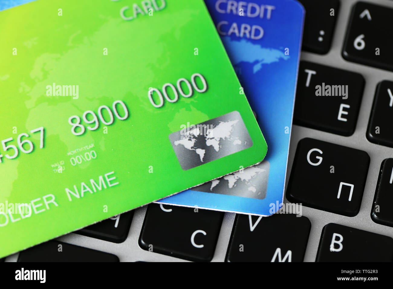 Credit cards on keyboard, close up Stock Photo - Alamy