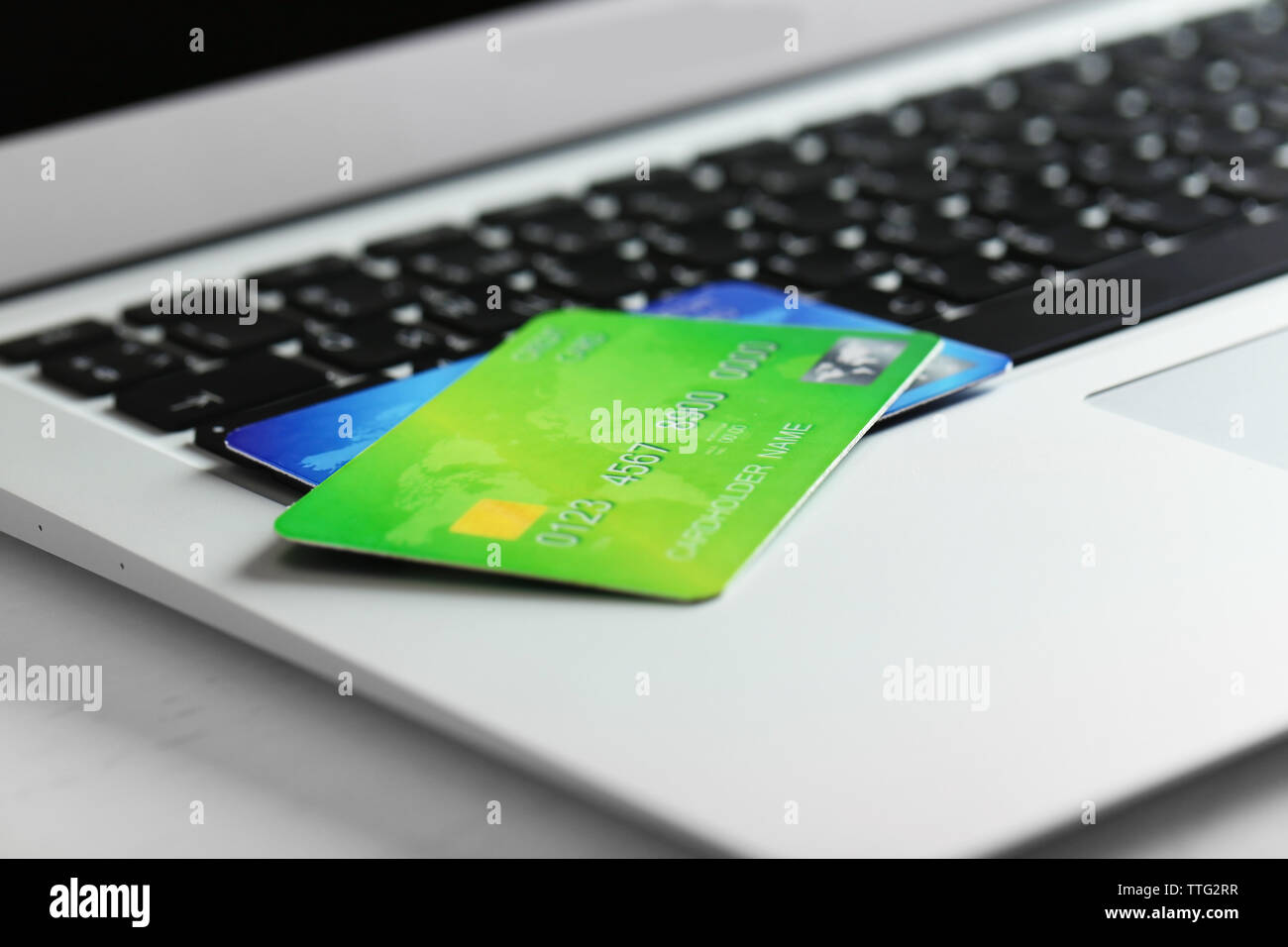 Credit cards on laptop, close up Stock Photo - Alamy