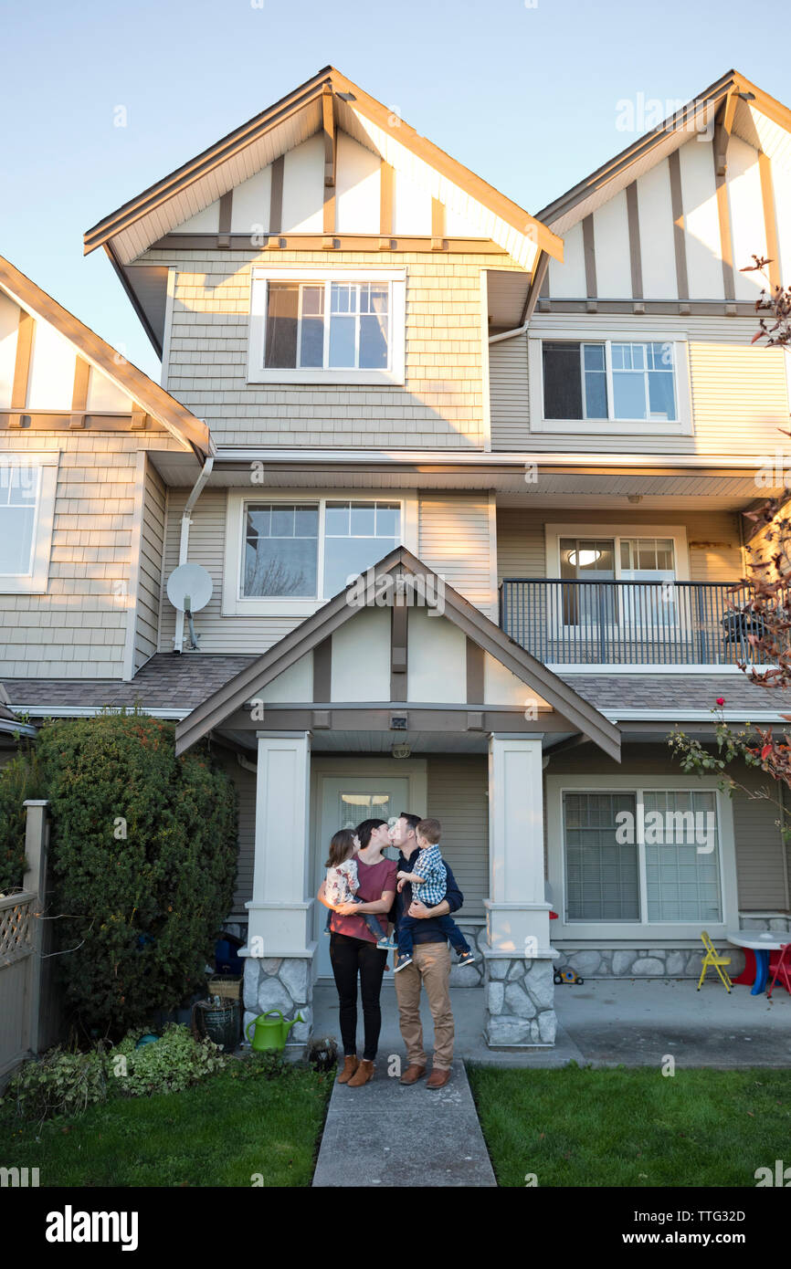 Family standing in front of house hi-res stock photography and images ...