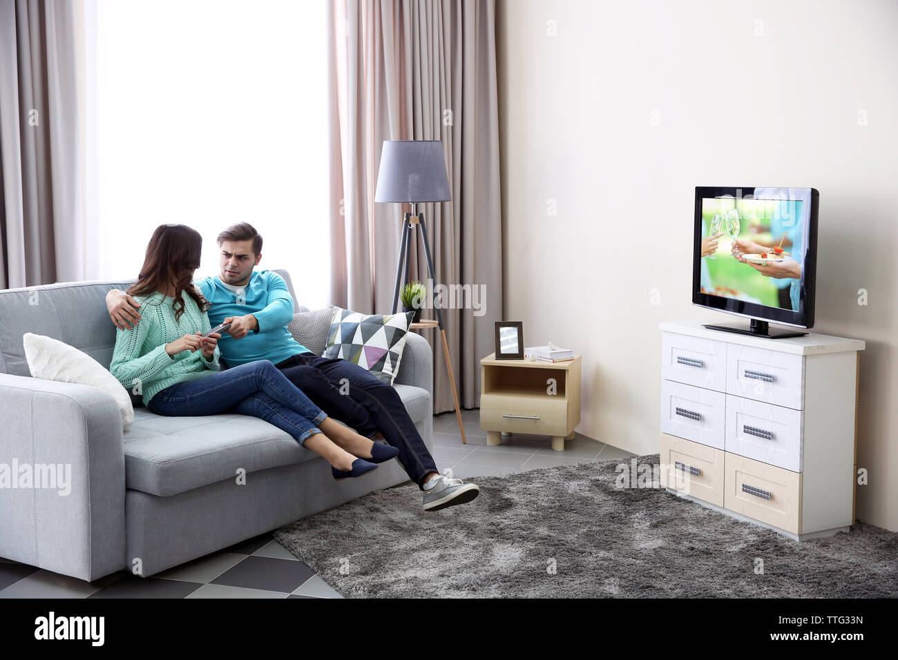 Fighting for the tv remote hi-res stock photography and images - Alamy