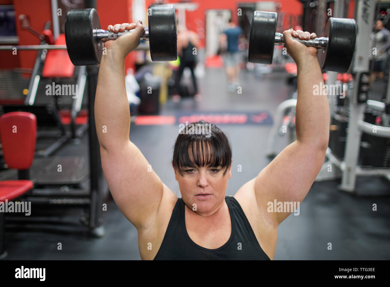 Strong woman lifting weights at the gym Stock Photo - Alamy