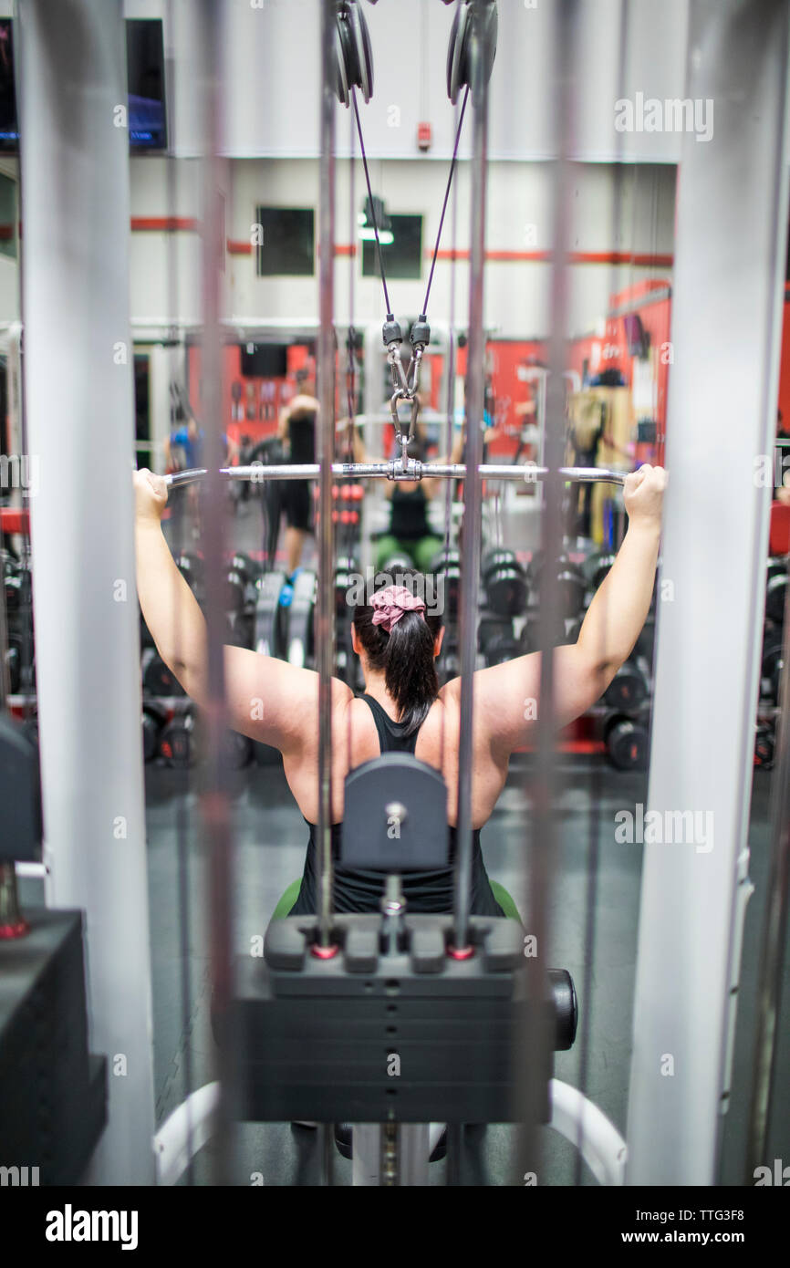 Strong woman completes shoulder pull-down at the gym Stock Photo - Alamy