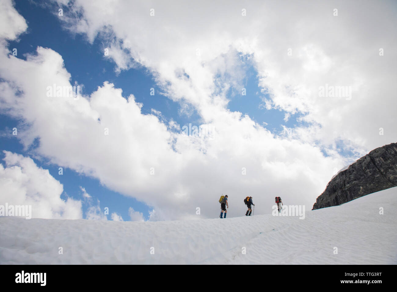 Three men climbing mountain hi-res stock photography and images - Alamy
