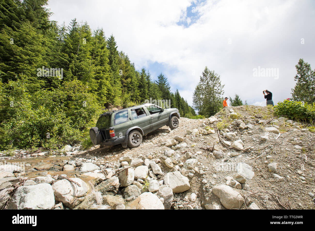 4x4 SUV driving up steep washed out dirt road in remote B.C Stock Photo ...