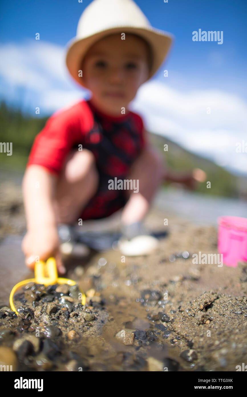 Child playing with rocks hi-res stock photography and images - Alamy
