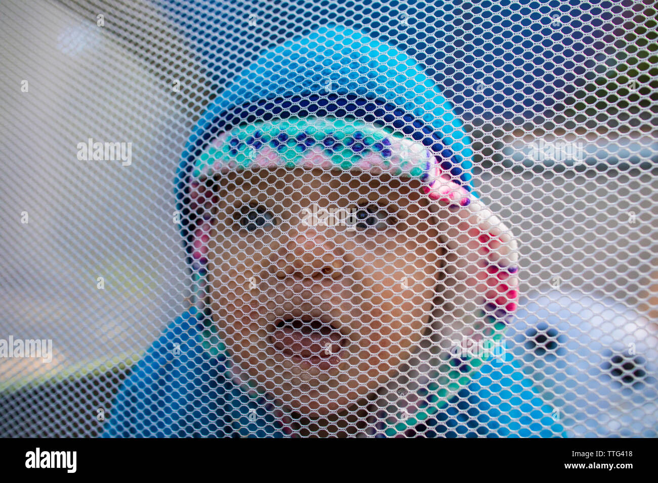 Low angle of baby girl in travel crib outside Stock Photo - Alamy