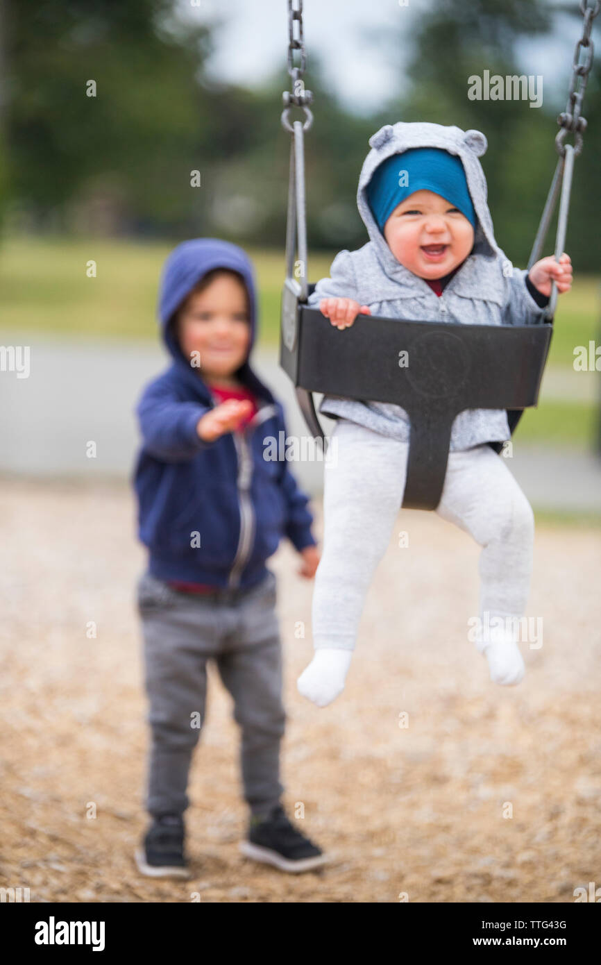 Pushing baby on swing hi-res stock photography and images - Alamy