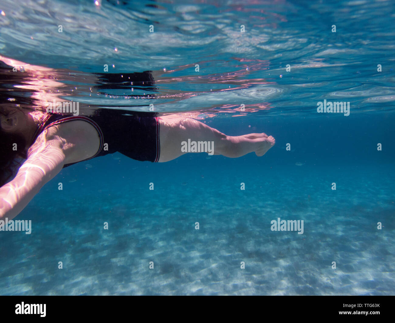 Low section of woman swimming in sea Stock Photo - Alamy