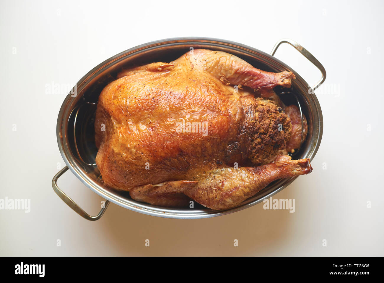 Overhead view of roasted turkey meat in container against white ...