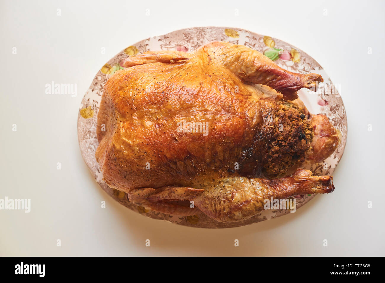Overhead view of roasted turkey meat in plate against white background ...