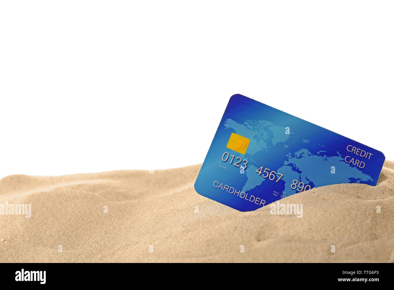 Blue bank card in sand isolated on white Stock Photo - Alamy
